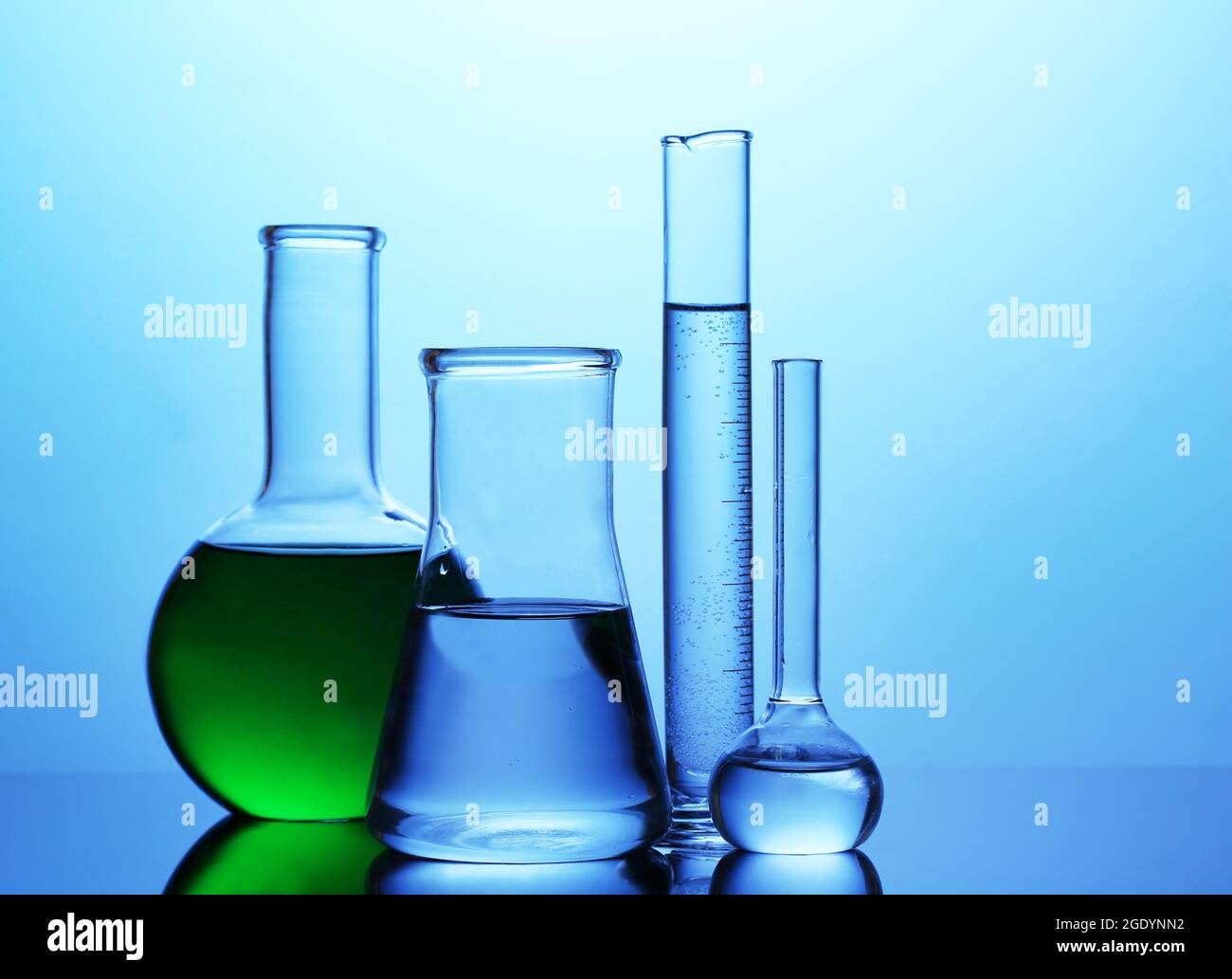 Test tubes with liquid on bright blue background Stock Photo - Alamy