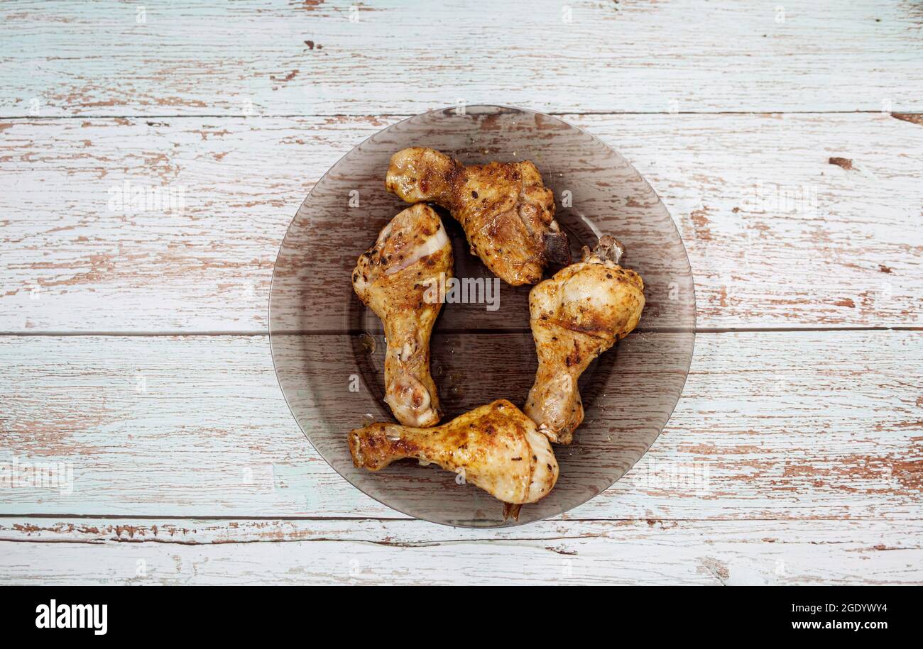 Grilled chicken drumsticks on plate. Top view Stock Photo - Alamy
