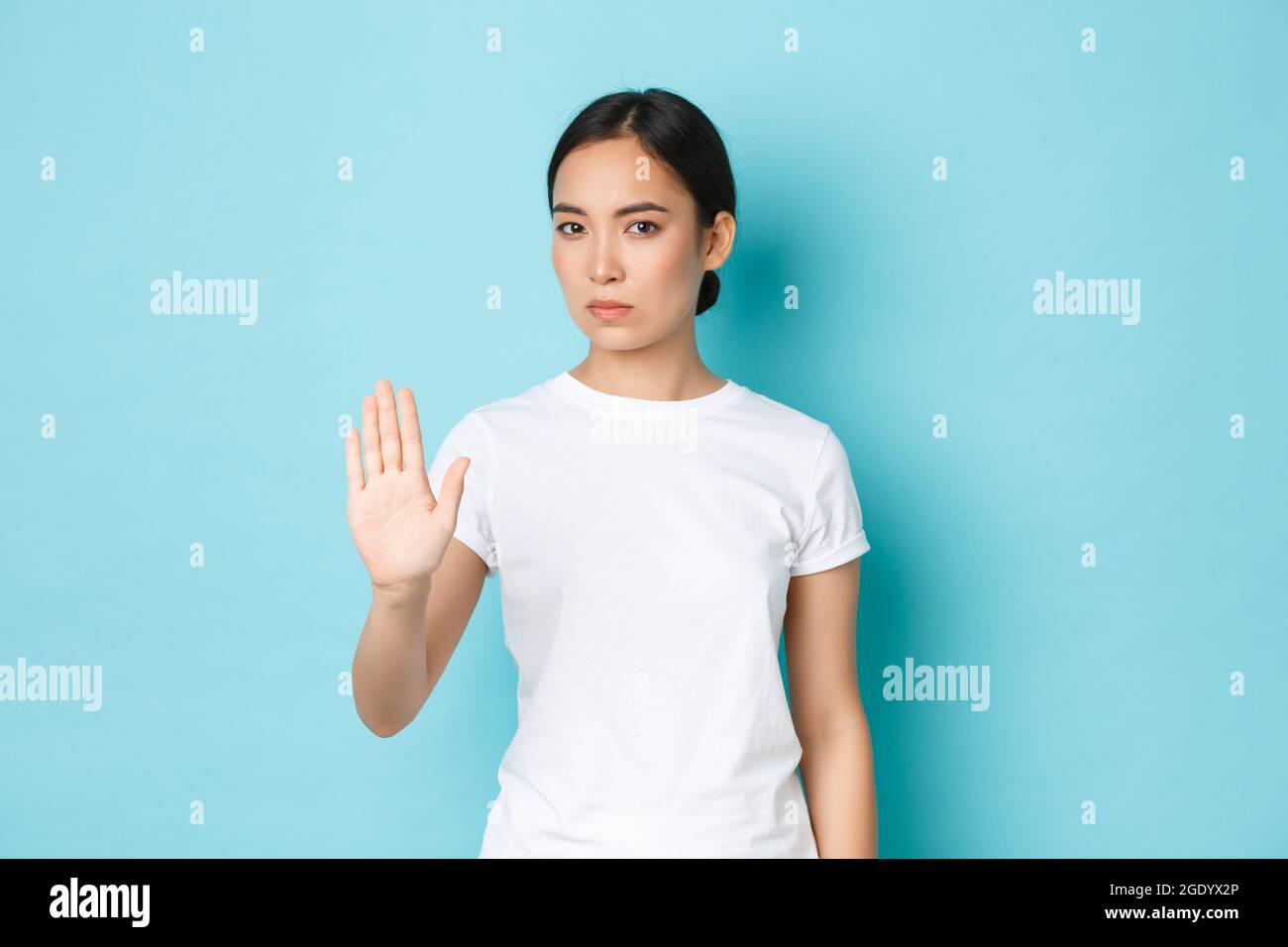 Serious confident asian woman stop something bad, raising hand in ...