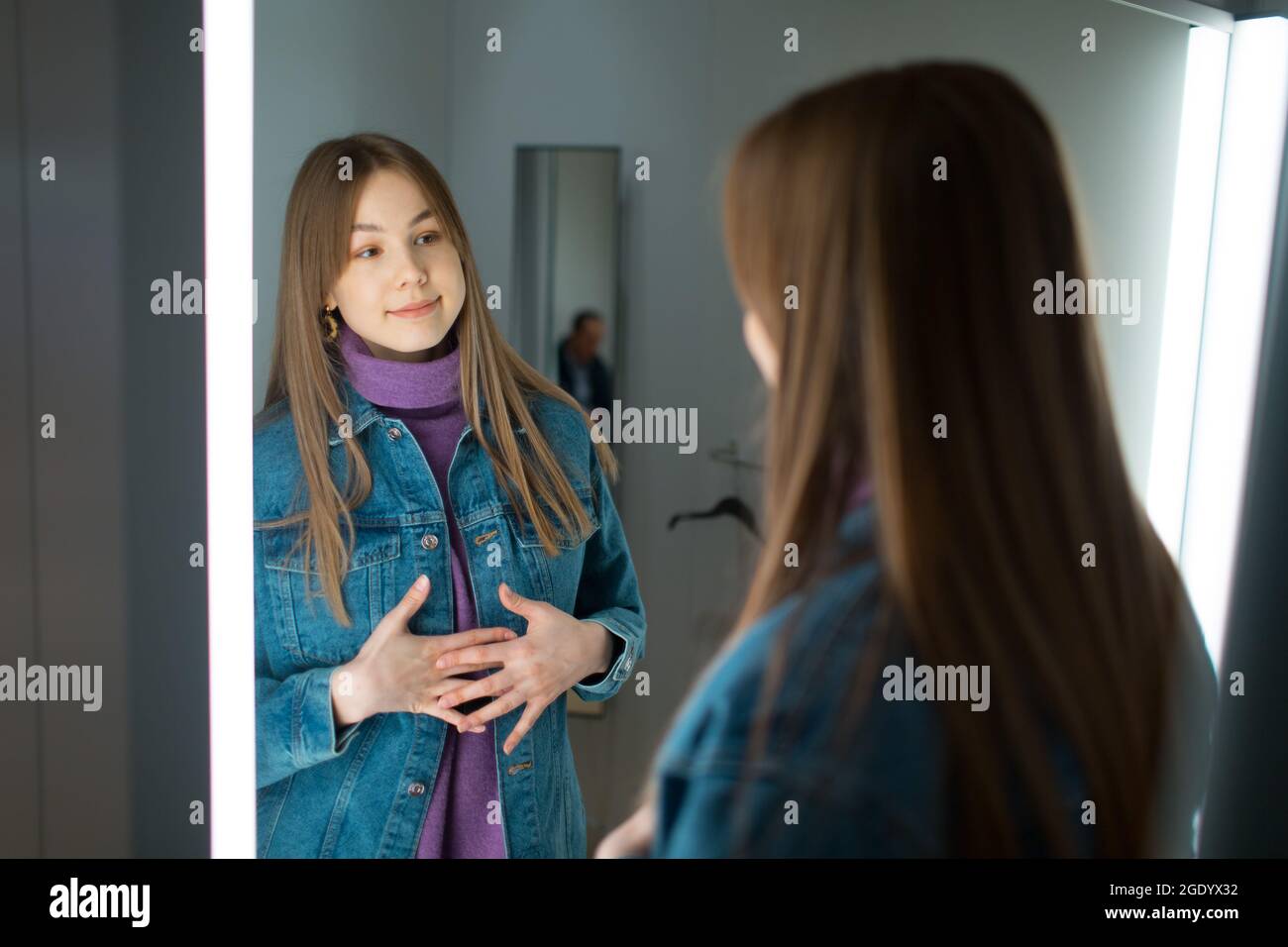 Young woman try on clothes in dressing room with mirror in shop Stock ...