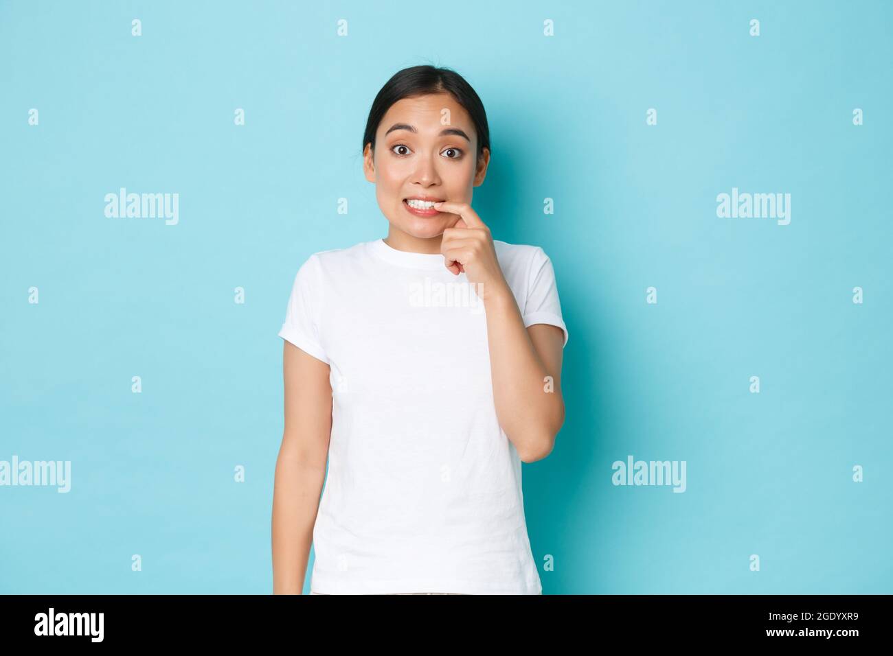 Asian girl biting finger hi-res stock photography and images - Alamy