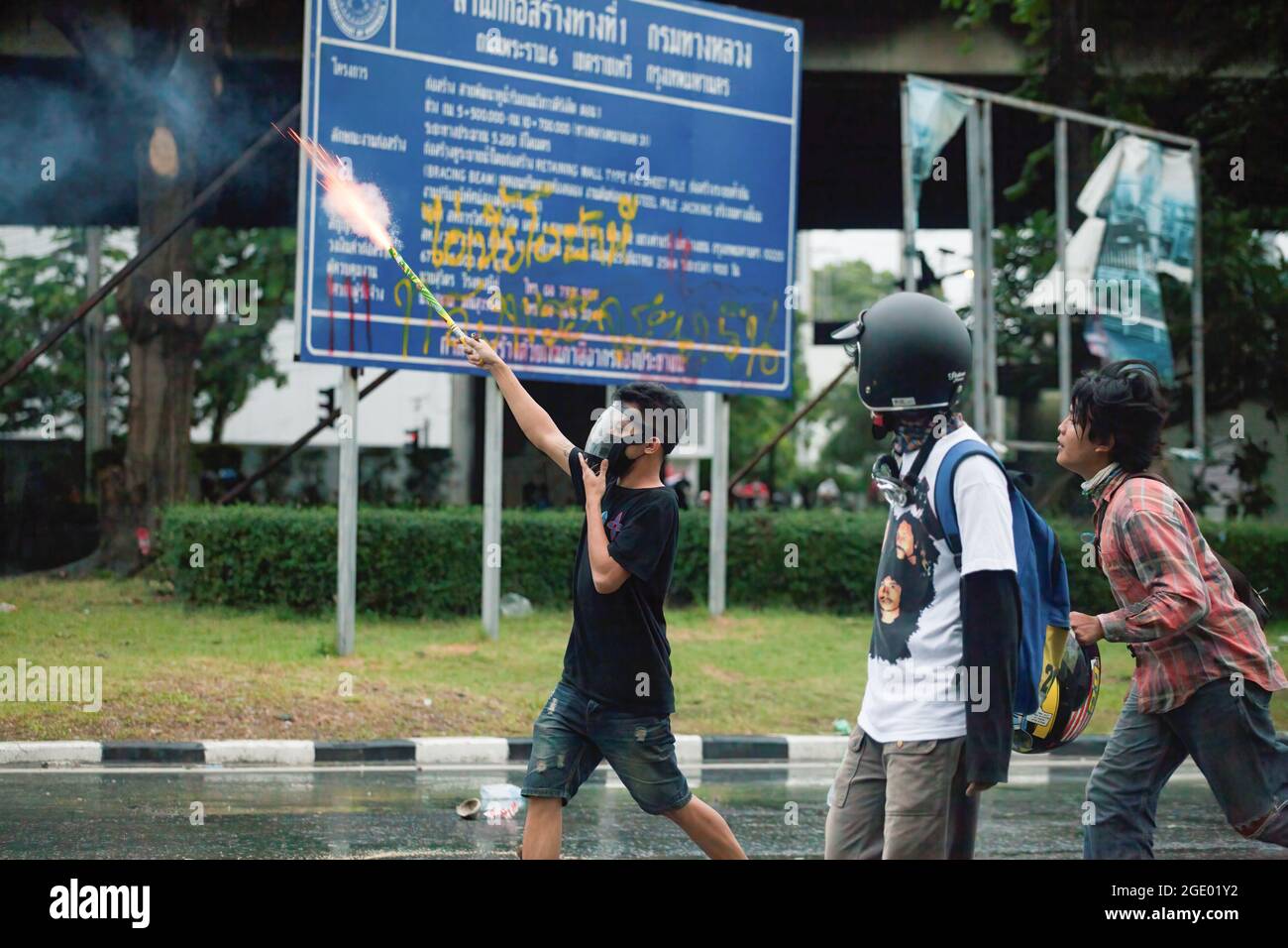 A protester holding a fire cracker during clashes. Thai anti-government ...