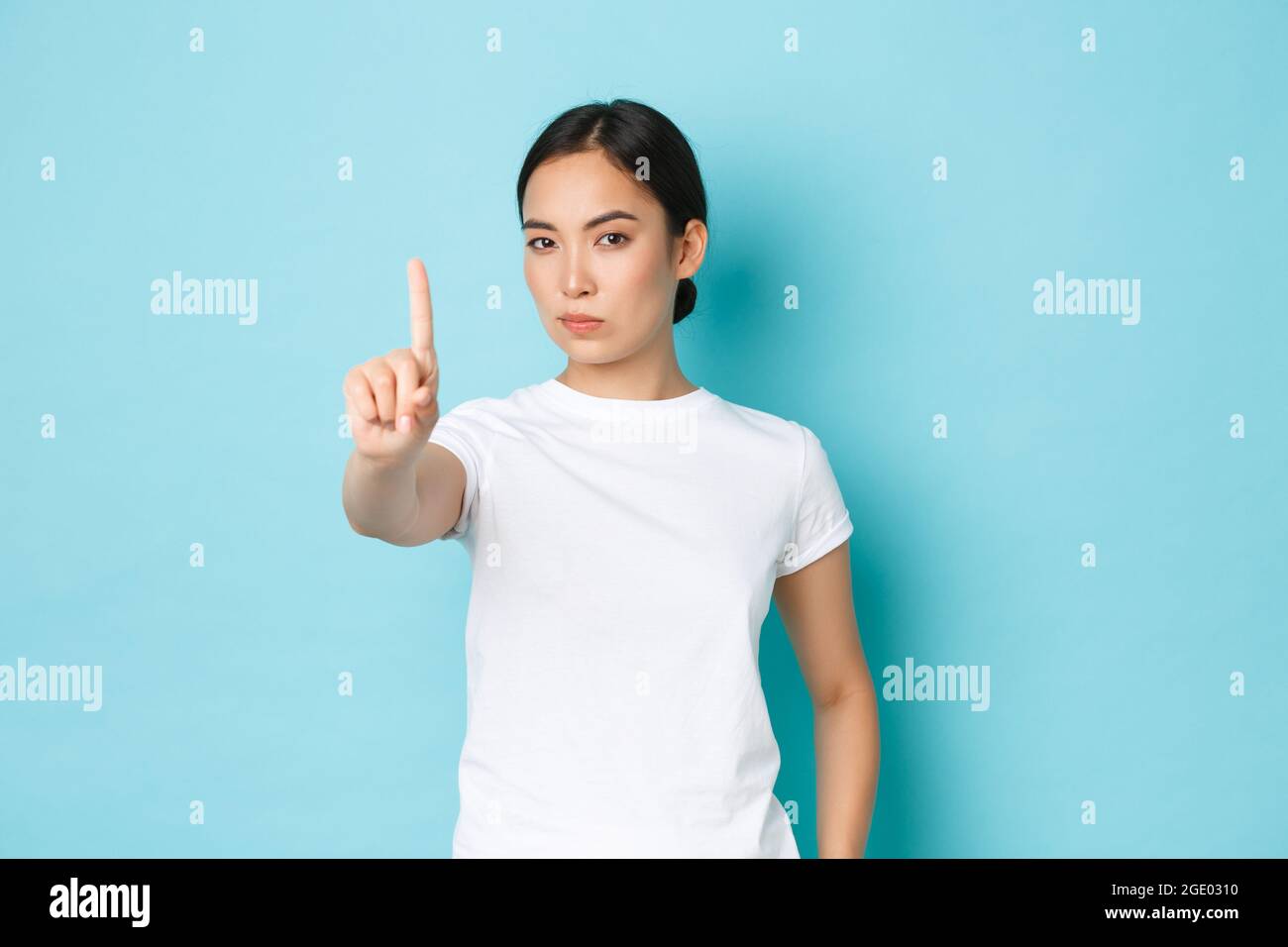 Serious-looking assertive young asian woman forbid action, express ...