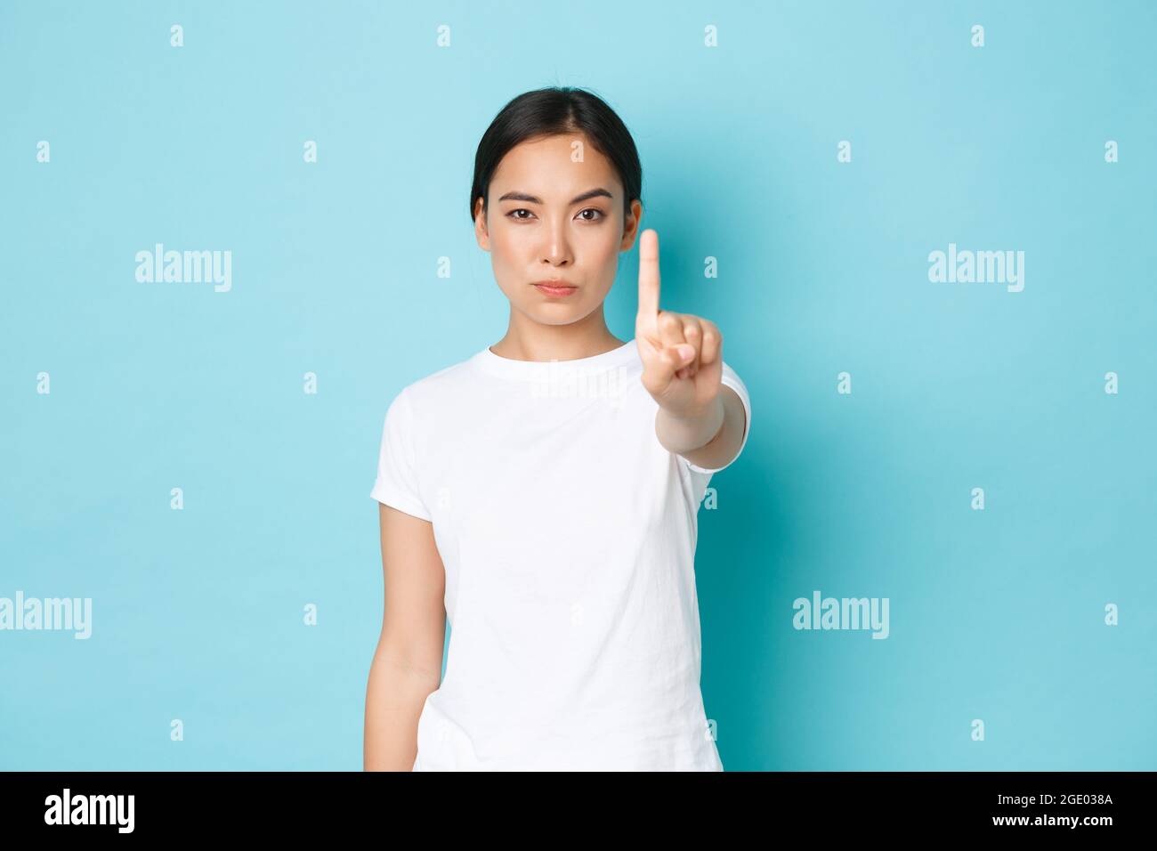 Serious-looking assertive young asian woman forbid action, express ...