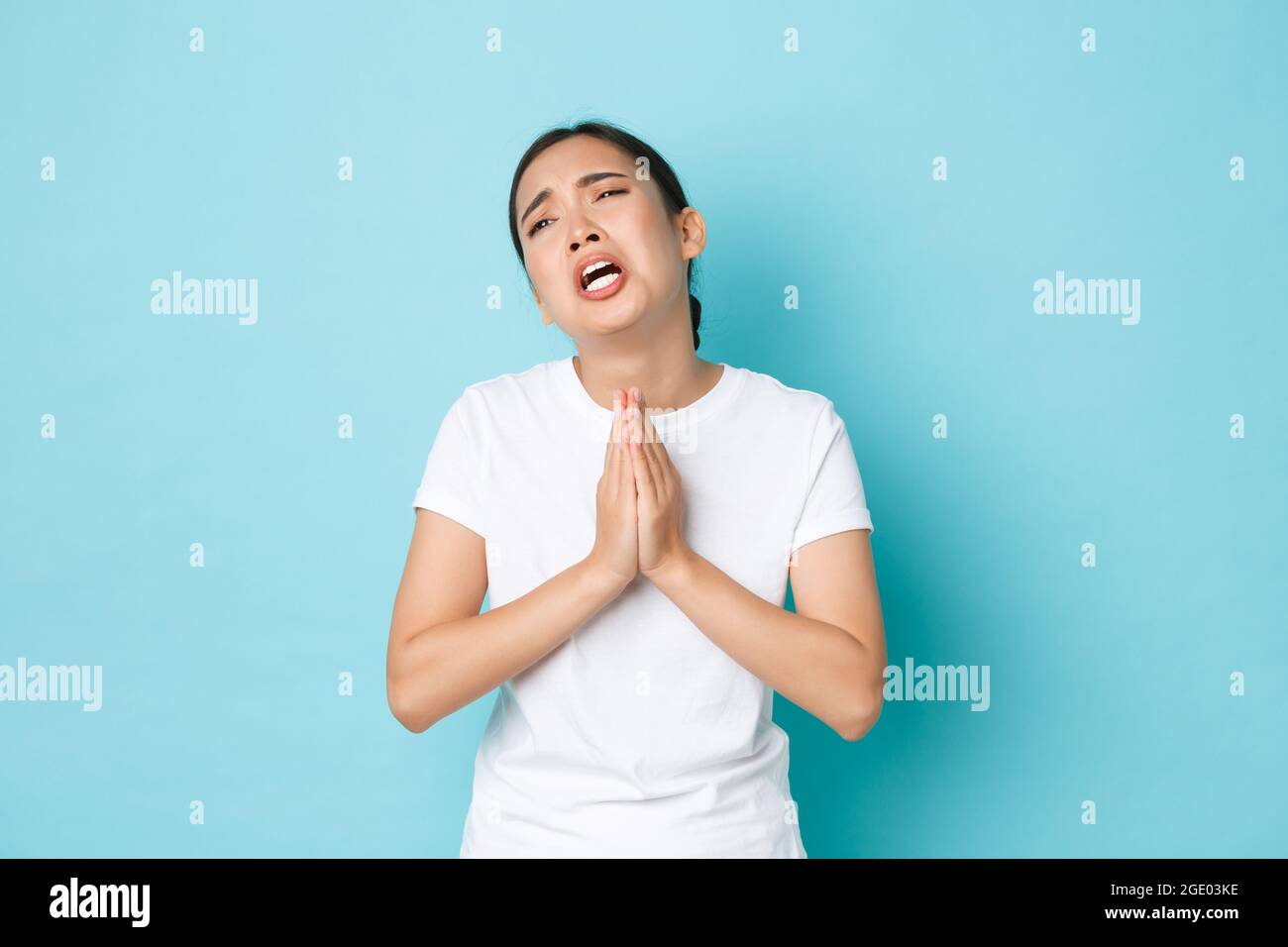 Desperate uneasy sad asian girl pleading for help, begging and crying ...