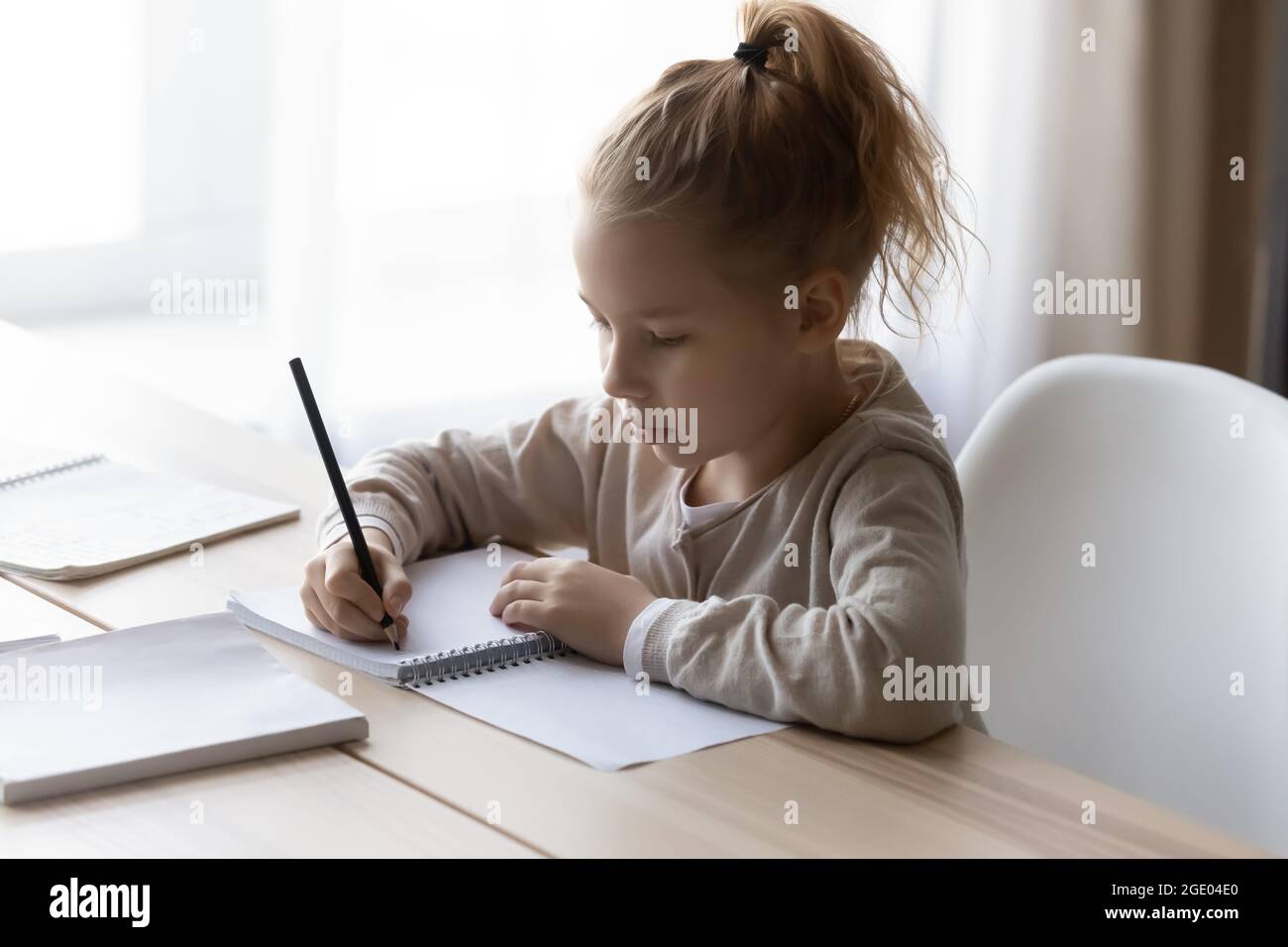 Smart girl child write prepare homework alone Stock Photo - Alamy