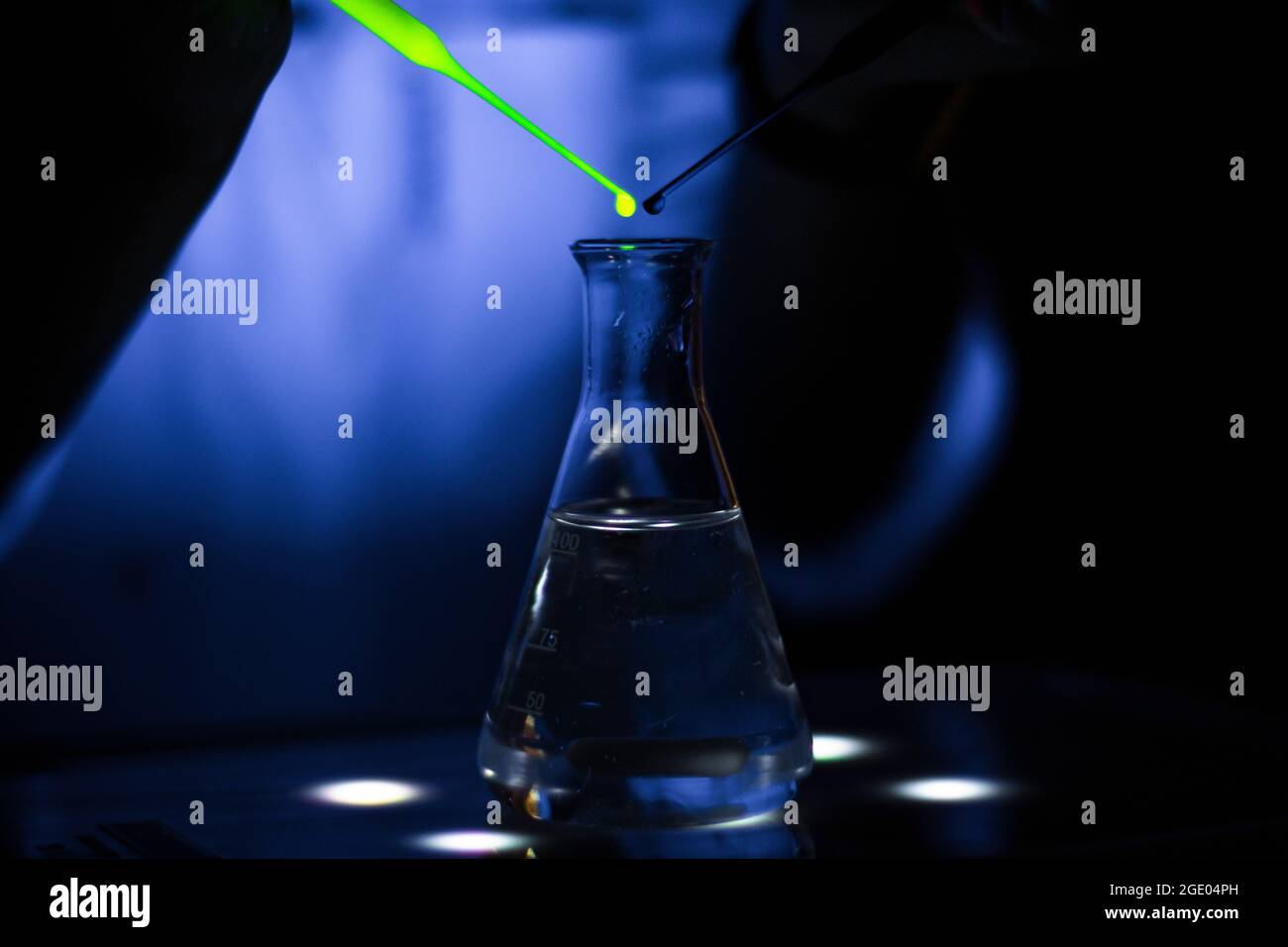An European researcher working with a green fluorescent compound in ...