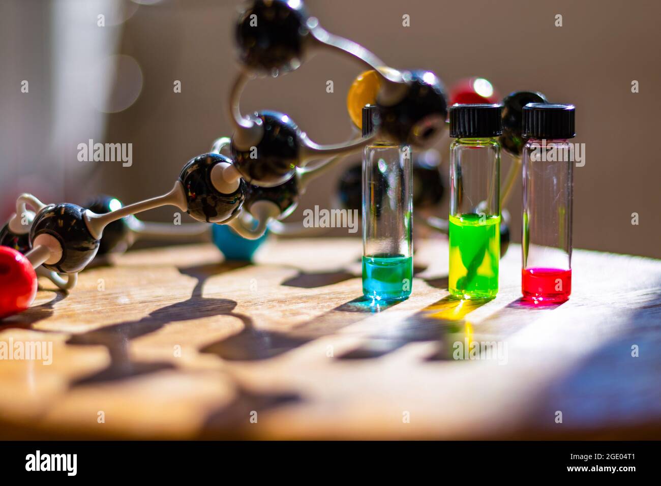 Colourful solutions in different vials with capillary under the light ...