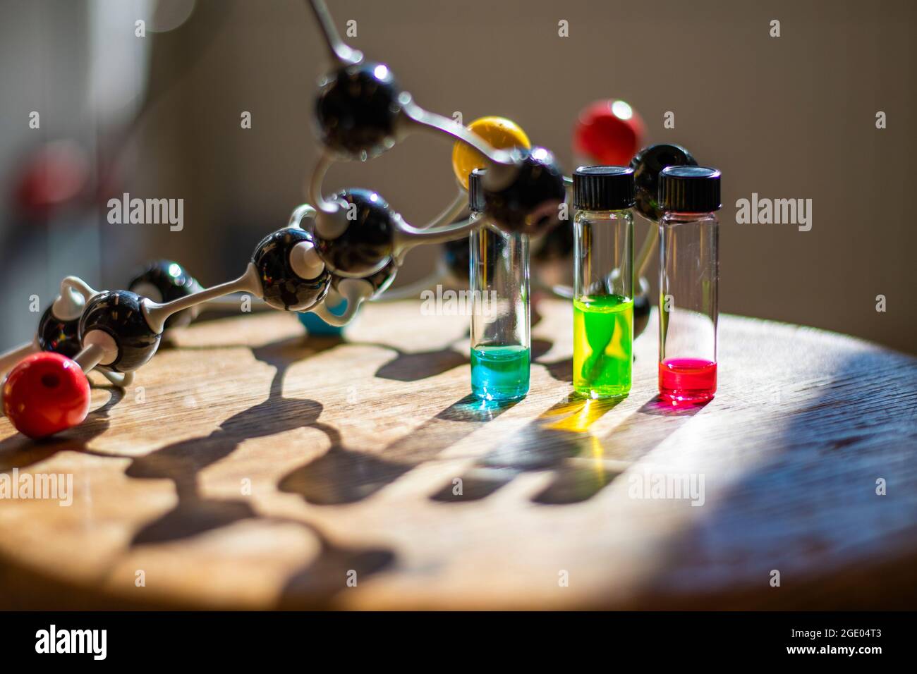 Colourful solutions in different vial with capillary under the light ...