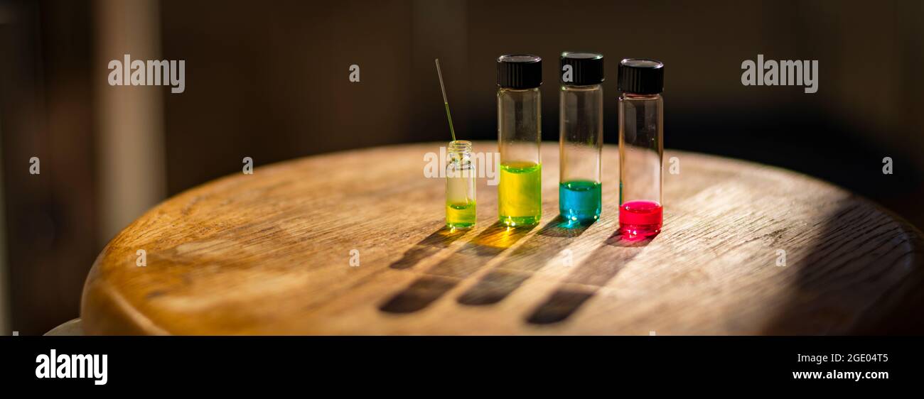 Colourful solutions in different vial with capillary under the light in ...