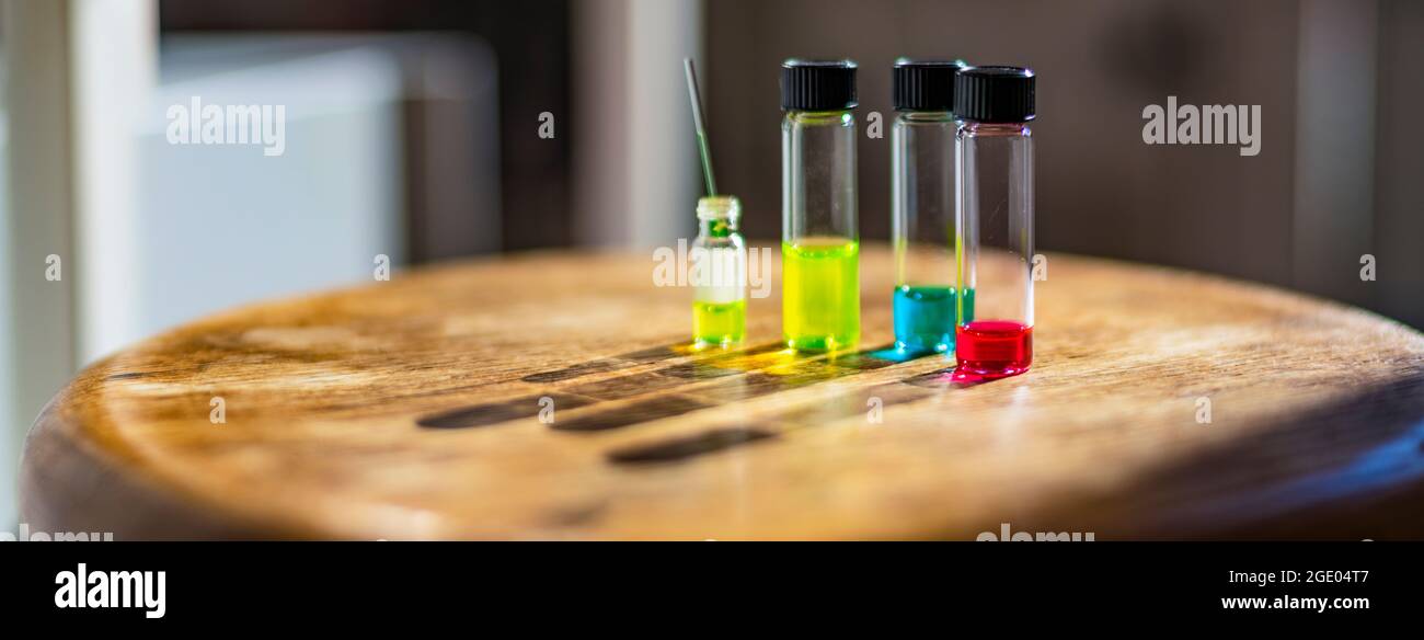 Colourful solutions in different vial with capillary under the light in ...