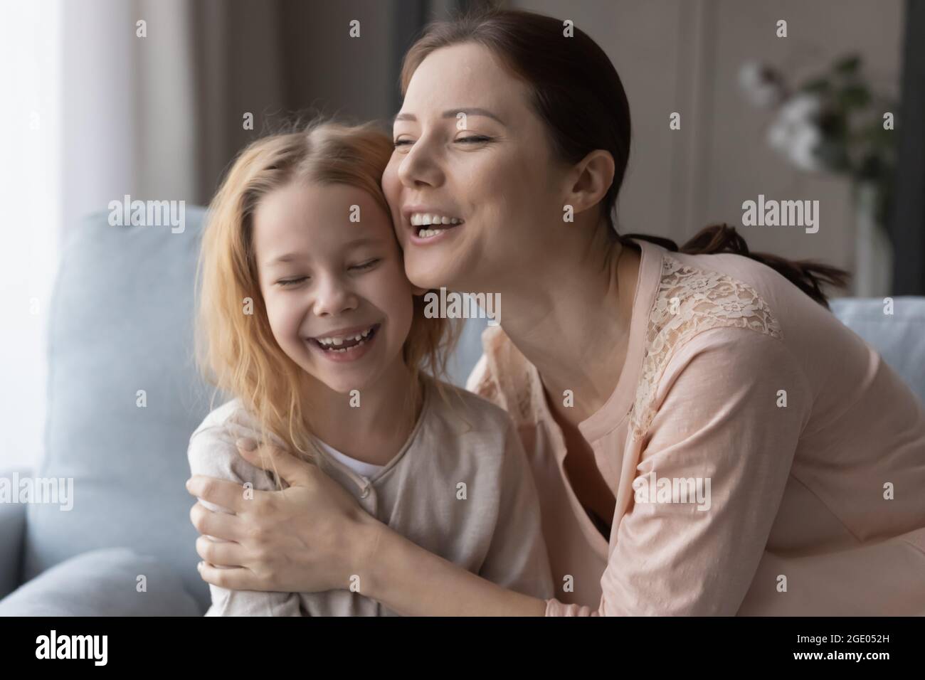 Happy mom and small daughter hug and cuddle Stock Photo - Alamy