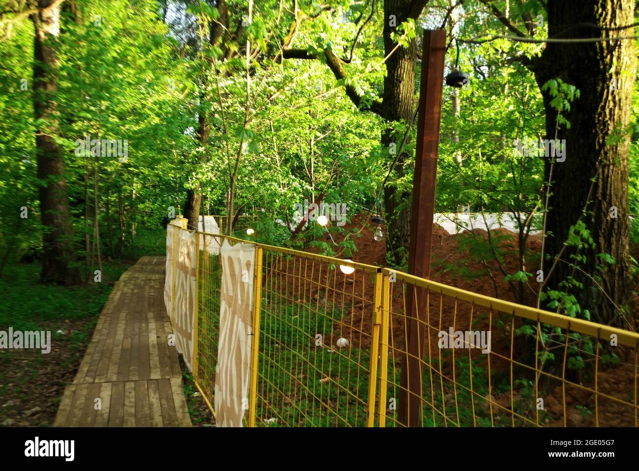 construction fence among the trees, Moscow Stock Photo - Alamy