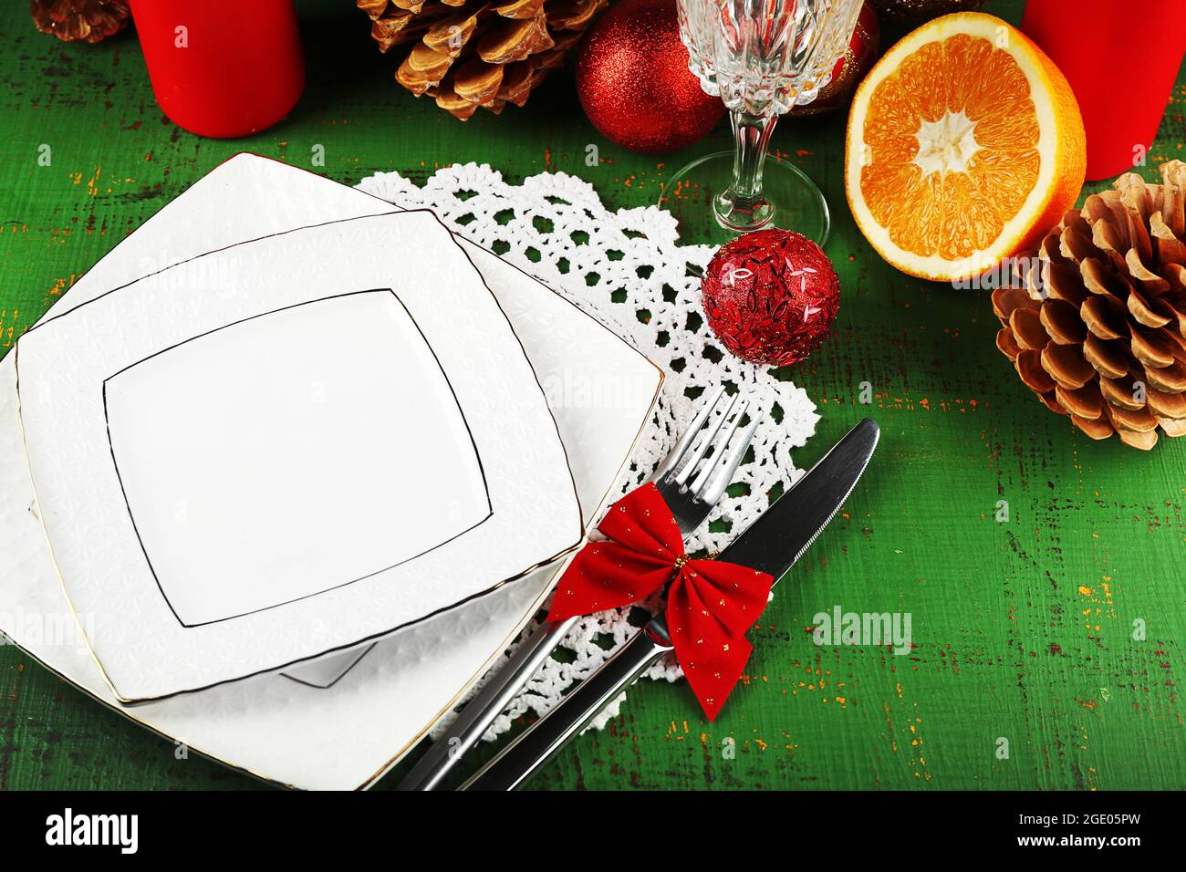 Table appointments with pieces of orange and Christmas decoration ...