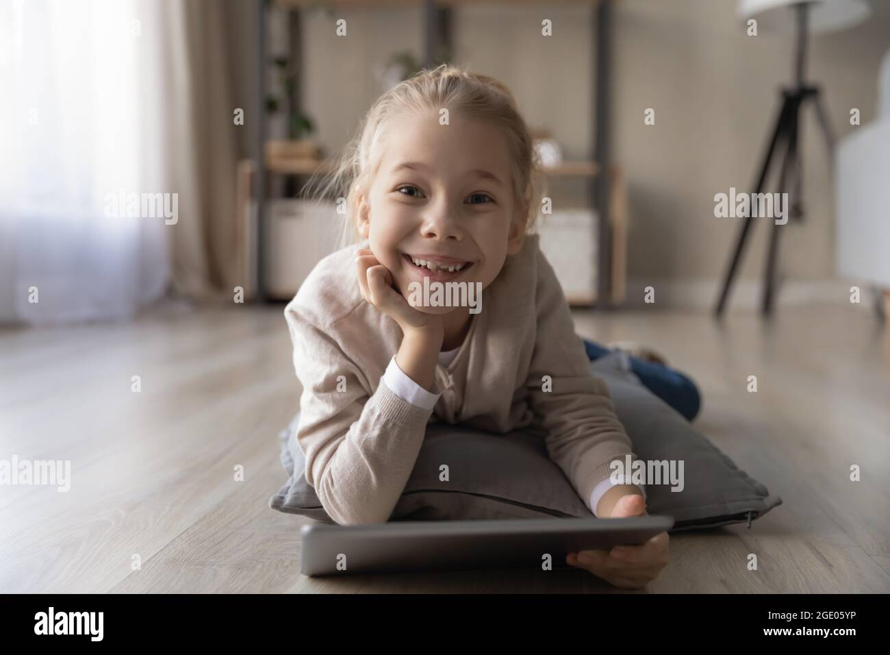 Portrait of smiling girl child relax using tablet Stock Photo - Alamy