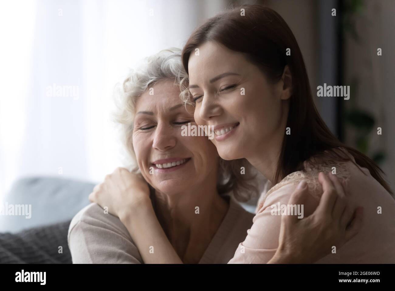 Happy grownup daughter and mature mom hugging Stock Photo - Alamy