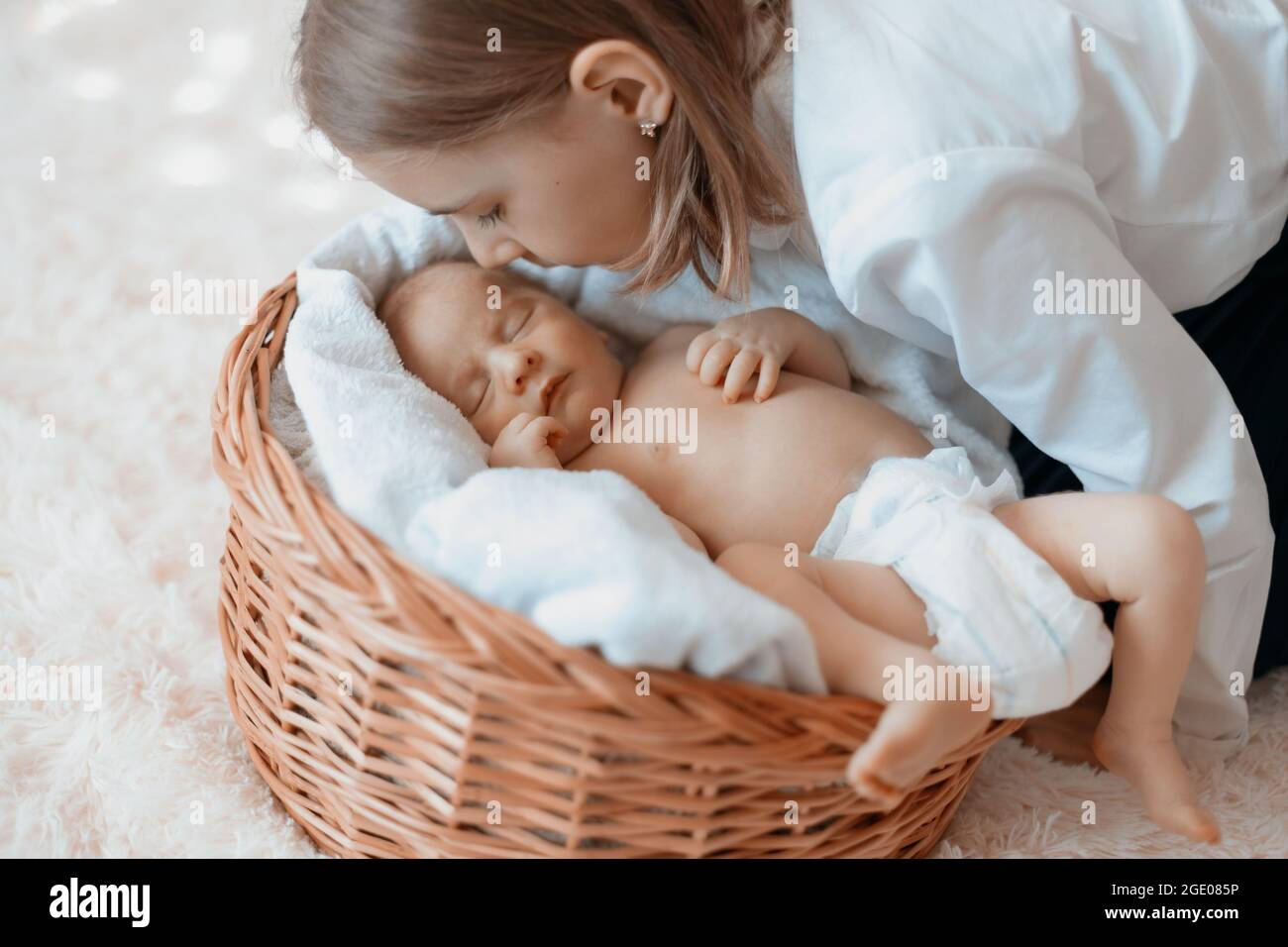 little girl looking at her newborn baby brother Stock Photo - Alamy