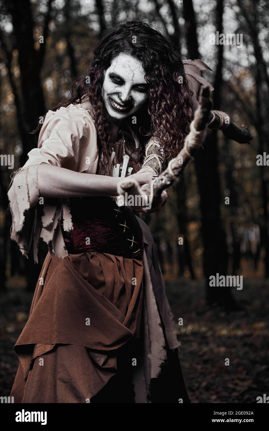 Halloween theme: terrible crazy voodoo witch killing by staff. Portrait ...
