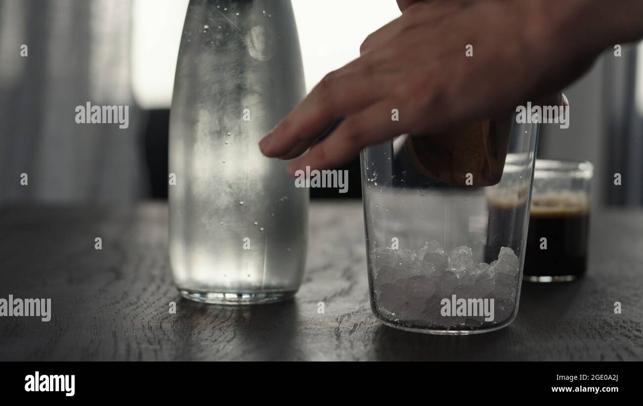 Making espresso tonic in tumbler glass, fill glass with crushed ice, wide photo Stock Photo - Alamy