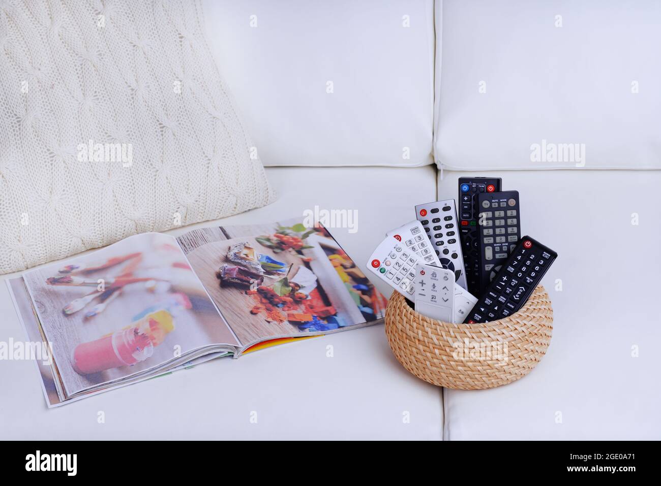 Many remote control devices on sofa Stock Photo - Alamy