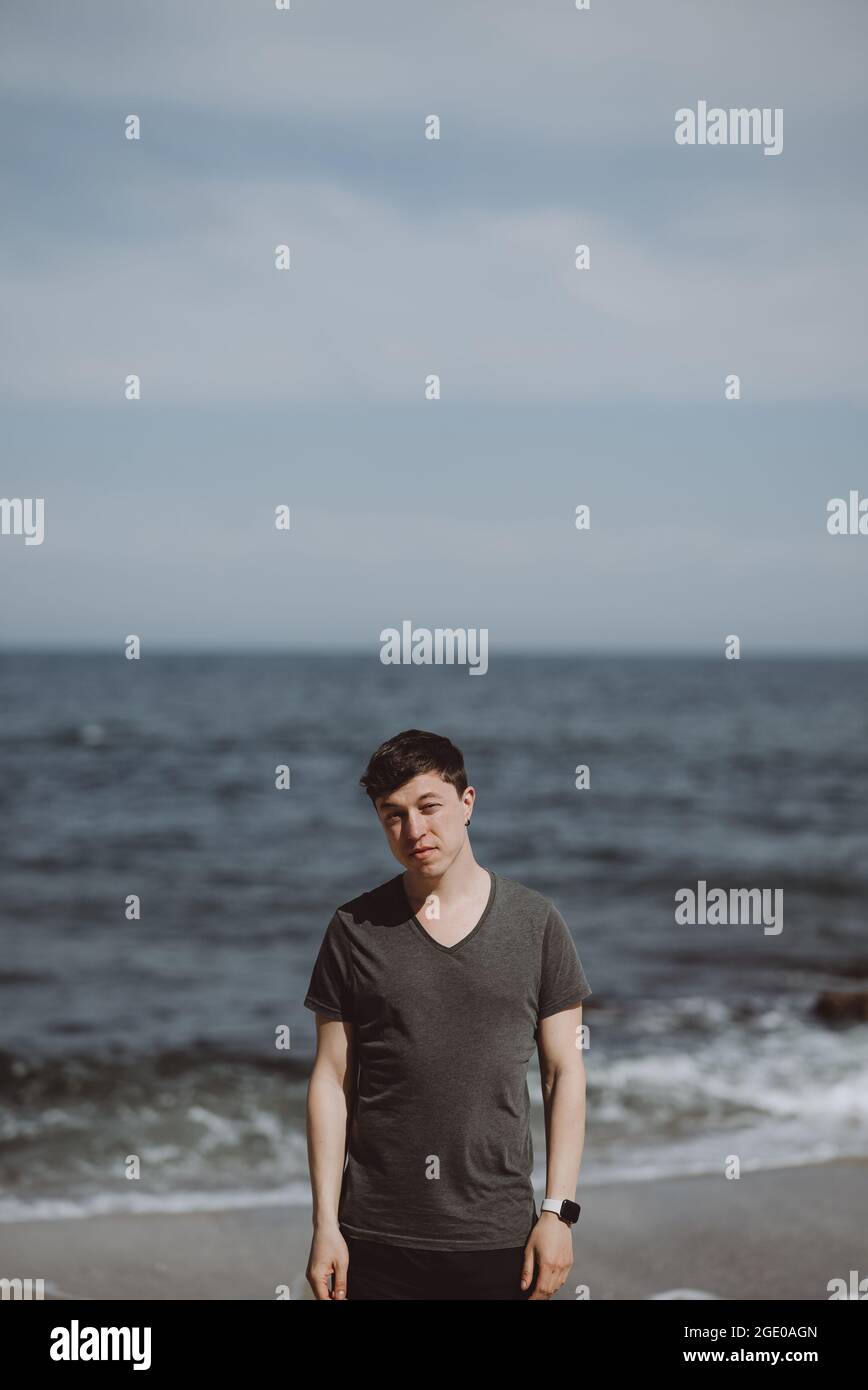 Handsome man posing on a background of sea Stock Photo - Alamy