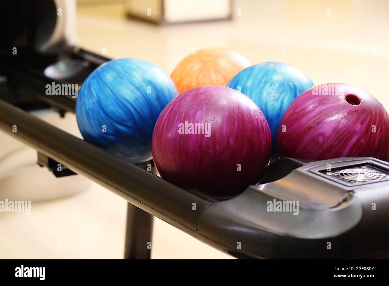 Colorful Bowling balls in ball return Stock Photo - Alamy