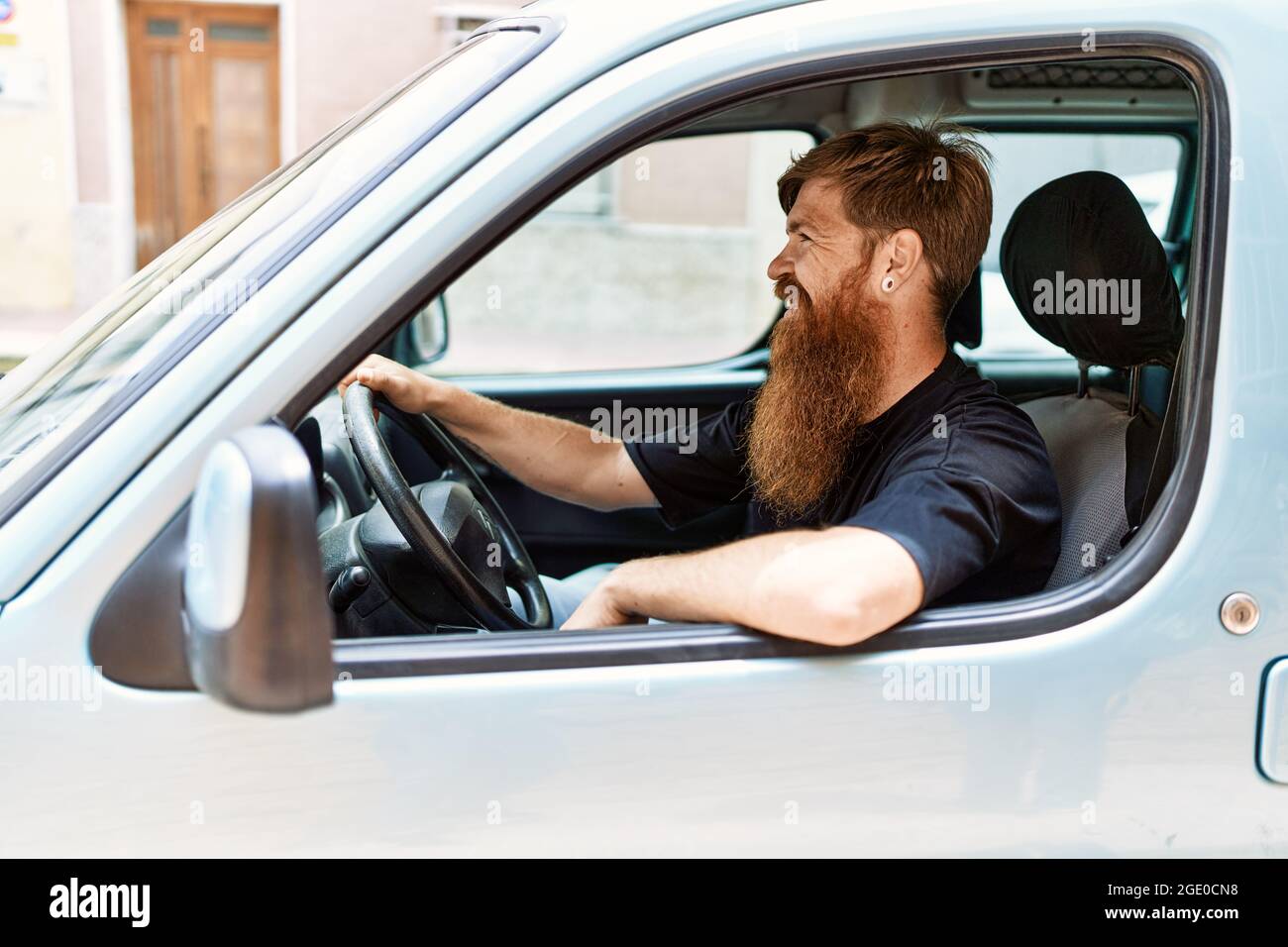 Young irish man smiling happy driving car at the city Stock Photo - Alamy