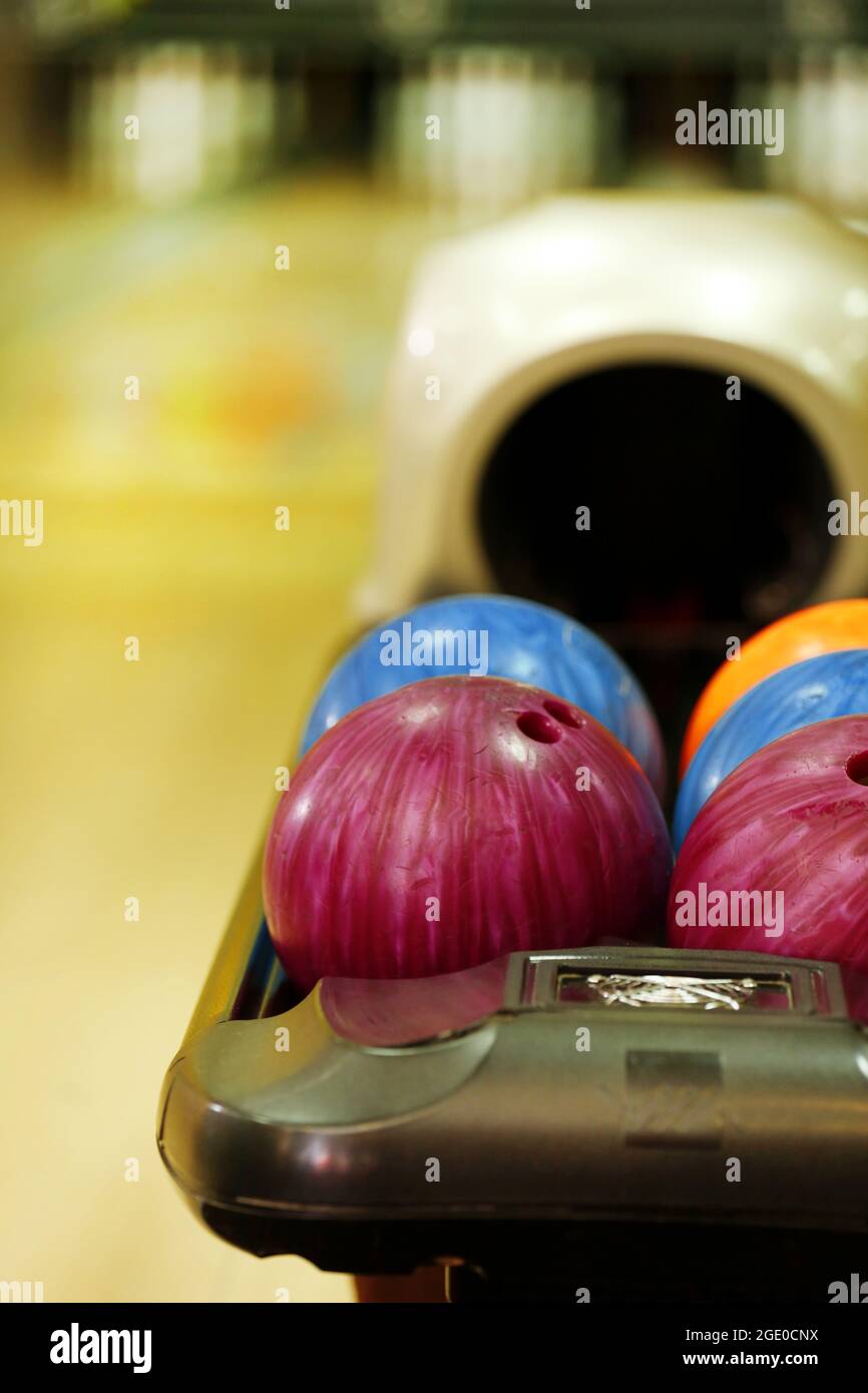 Colorful Bowling balls in ball return Stock Photo - Alamy