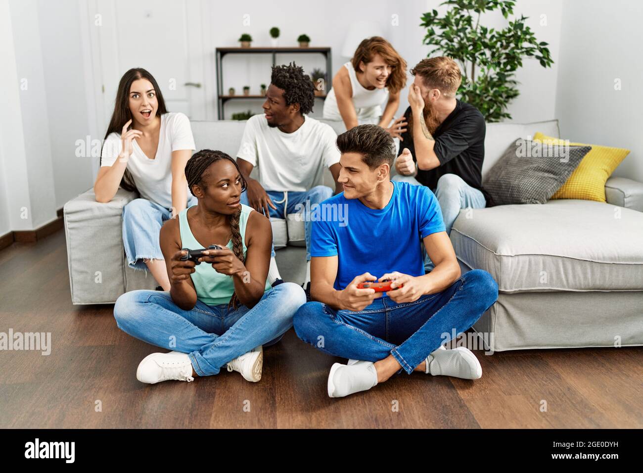 Group of young friends smiling happy playing video game at home Stock ...