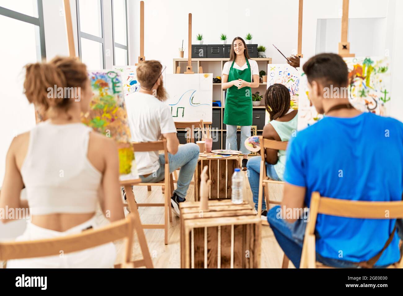 Group of people smiling happy drawing in paint class at art studio ...