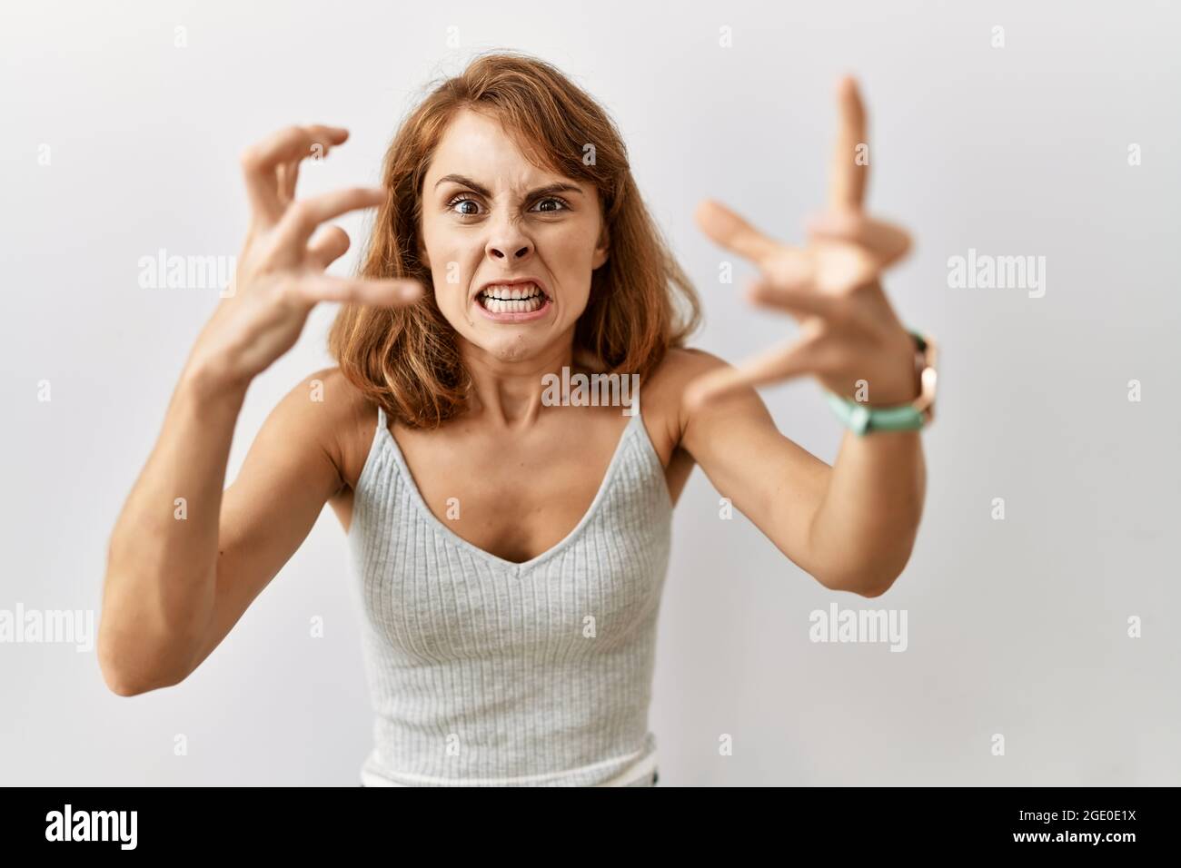 Beautiful caucasian woman standing over isolated background shouting ...
