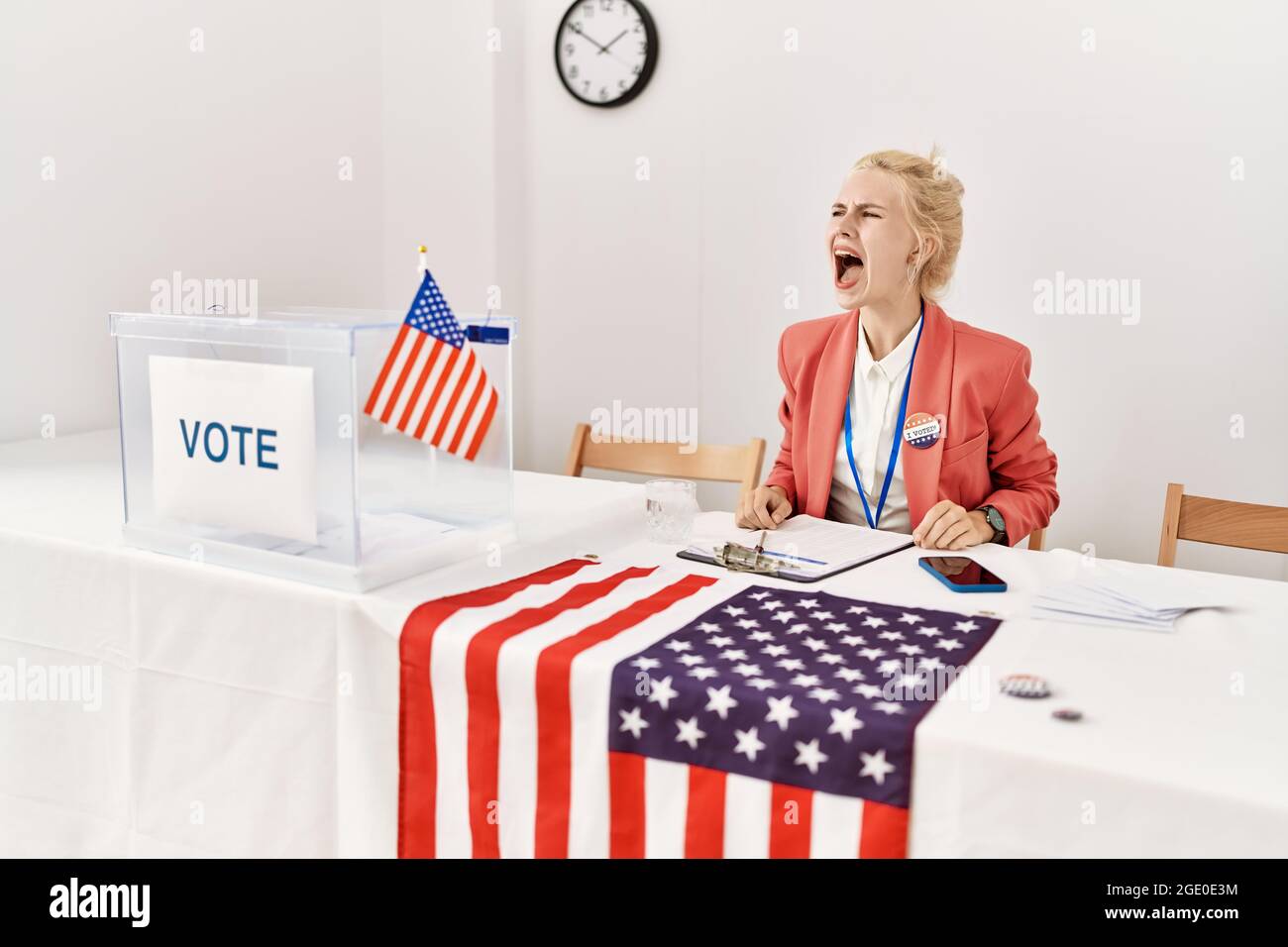 Beautiful caucasian woman working at political campaign angry and mad ...