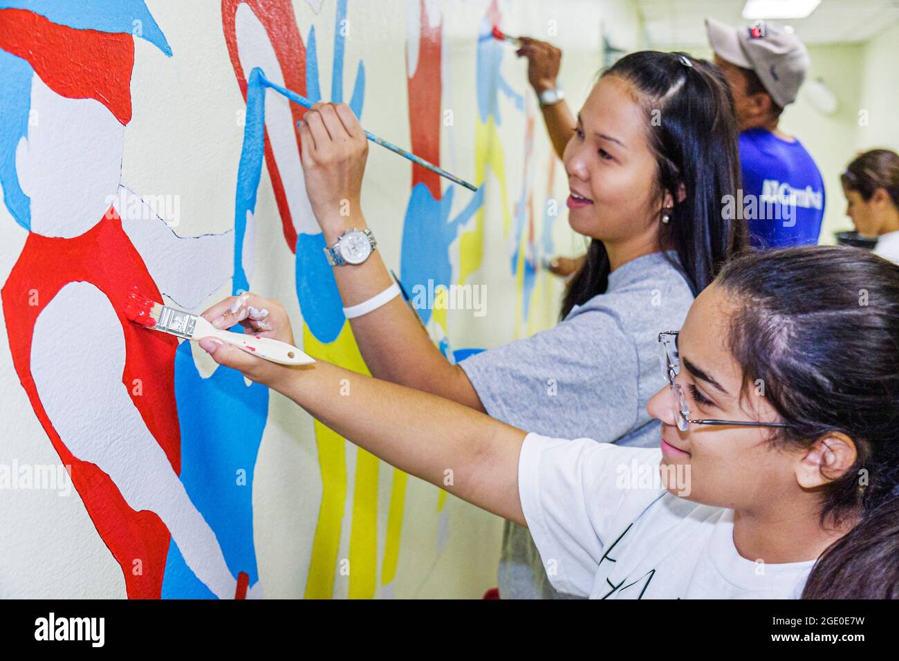 Miami Florida,volunteers volunteering working together painting mural ...