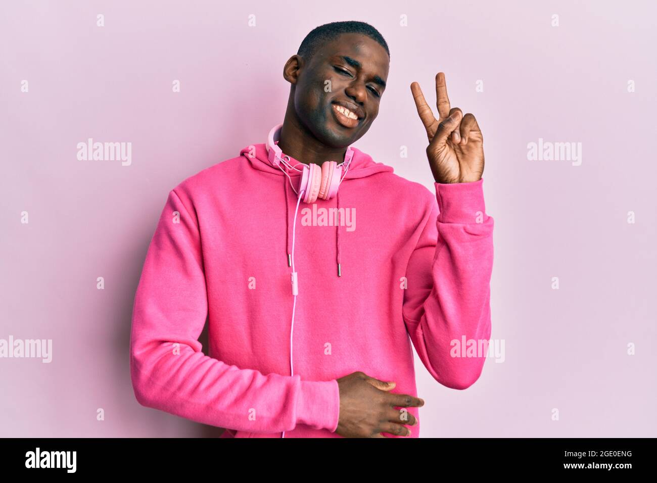 Young african american man wearing gym clothes and using headphones ...