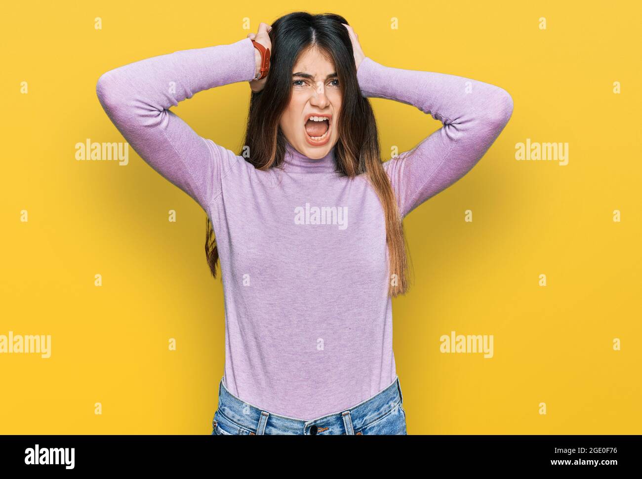 Young beautiful teen girl wearing turtleneck sweater crazy and scared ...