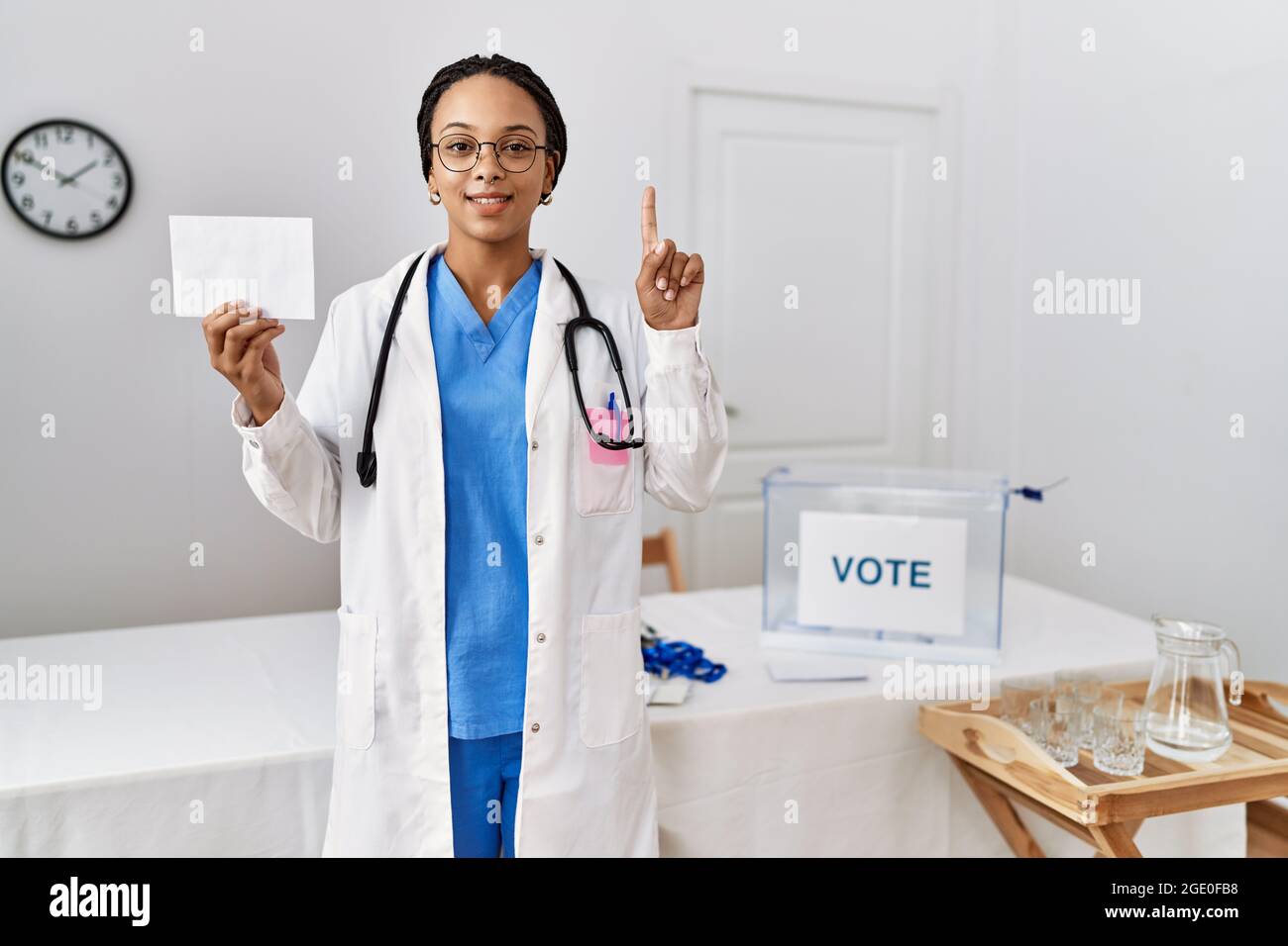 Young african american doctor woman voting holding envelope surprised ...