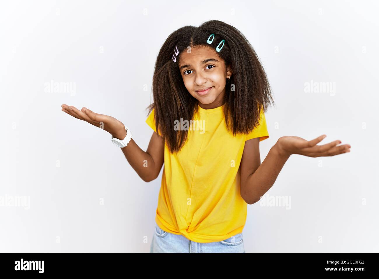 Young african american girl standing over white isolated background ...