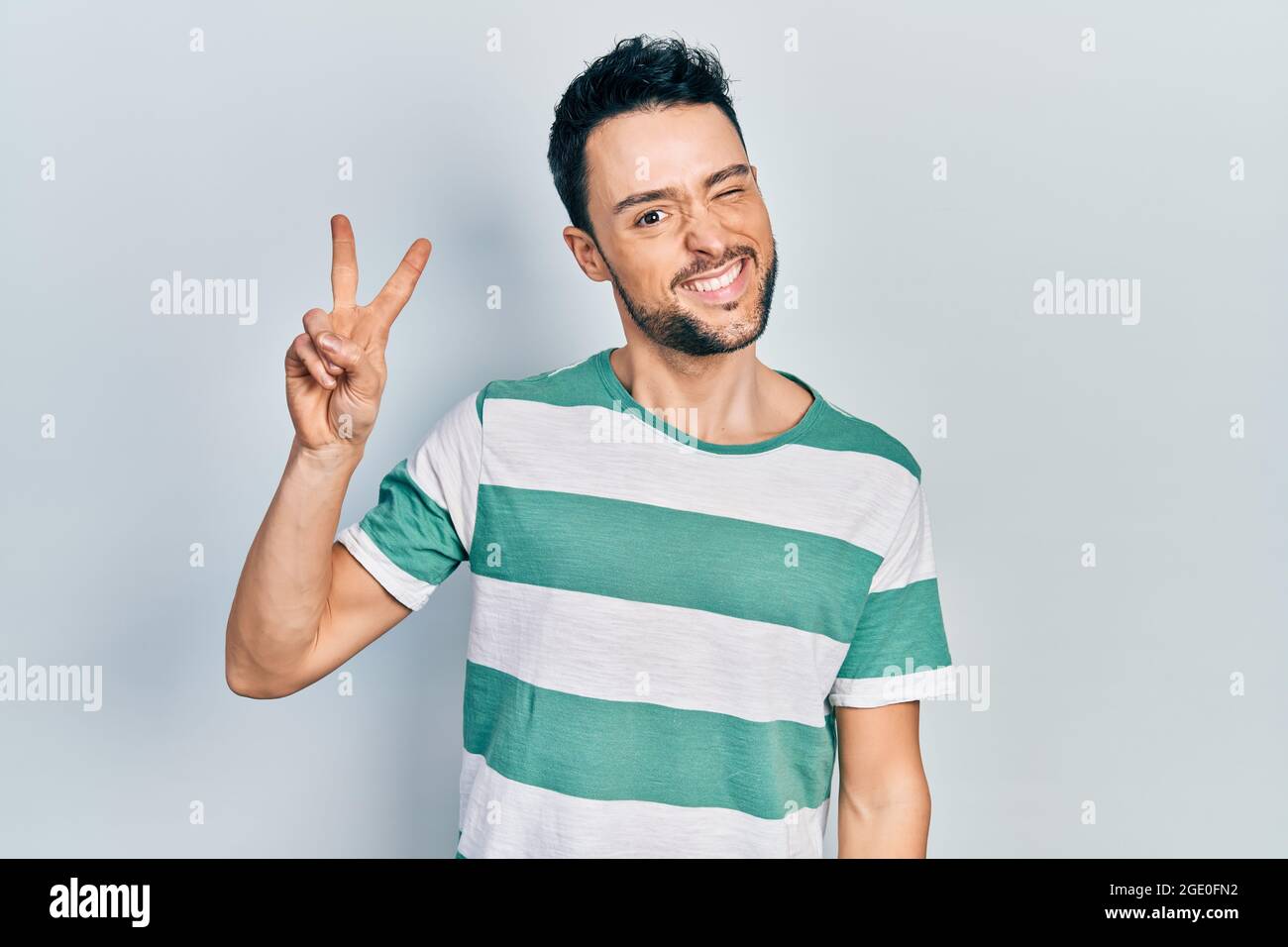 Young hispanic man wearing casual clothes smiling with happy face ...