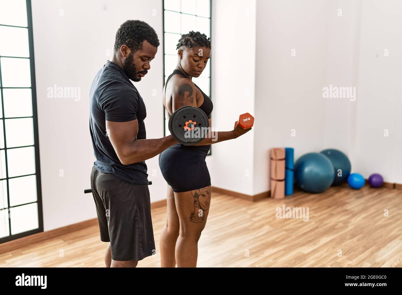 Young african american sporty couple training power exercise using ...