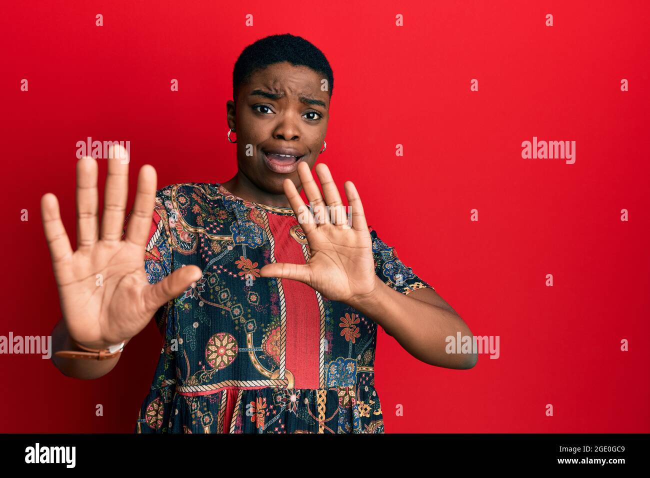 Young african american woman wearing african style afraid and terrified ...