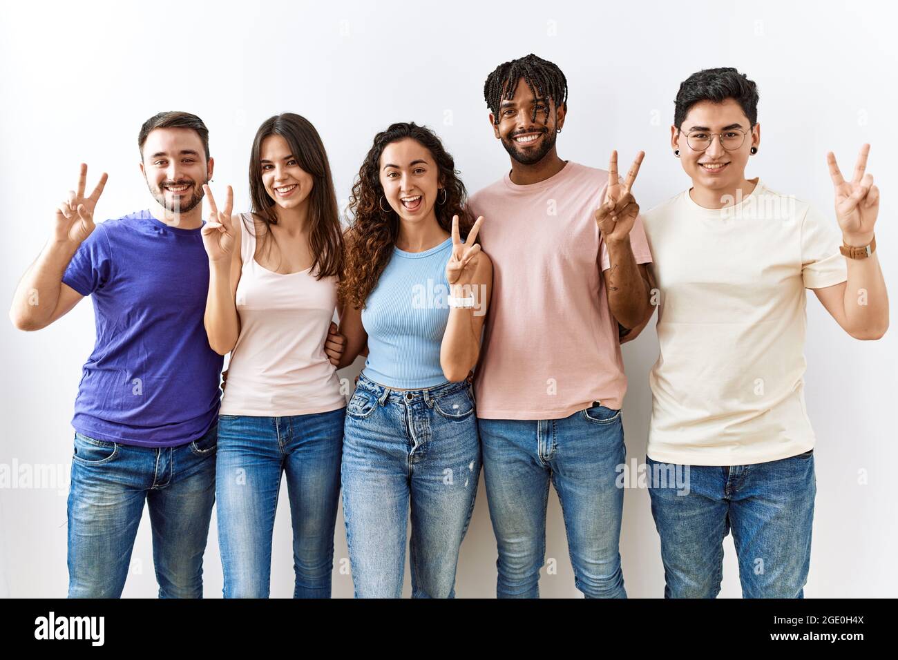 Group of young people standing together over isolated background ...