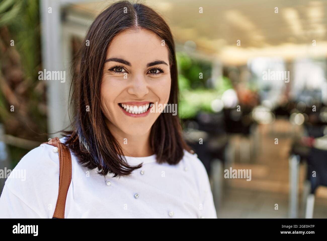 Young hispanic girl smiling happy standing at the city Stock Photo - Alamy