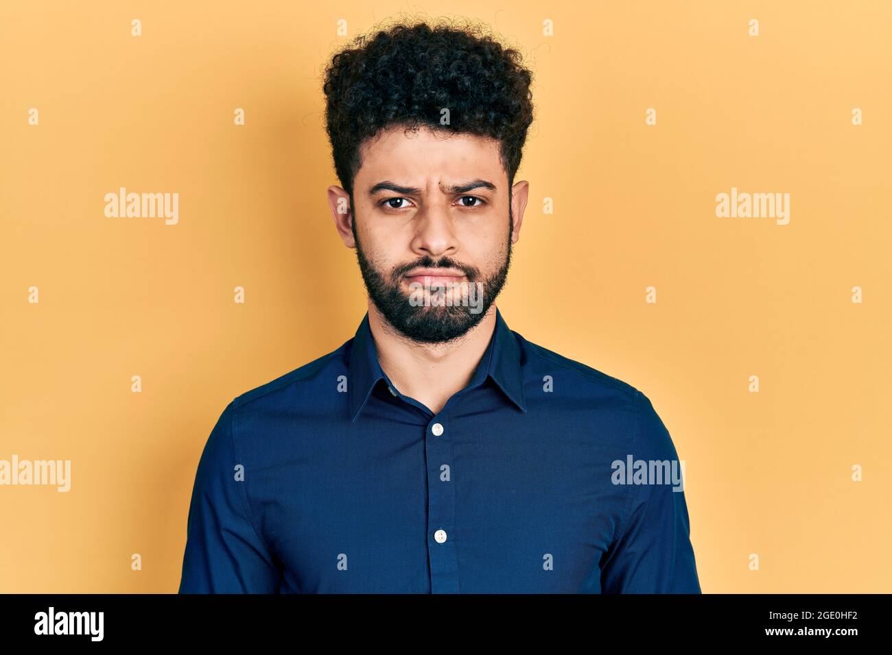 Young arab man with beard wearing casual shirt depressed and worry for ...