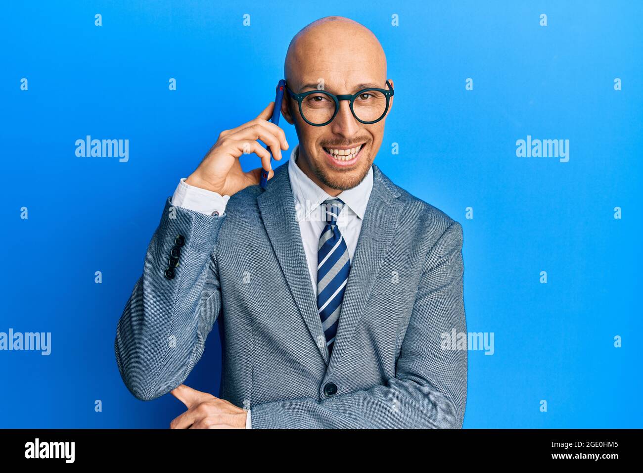 Bald man with beard having conversation talking on the smartphone ...