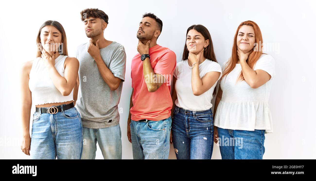 Group of young friends standing together over isolated background ...