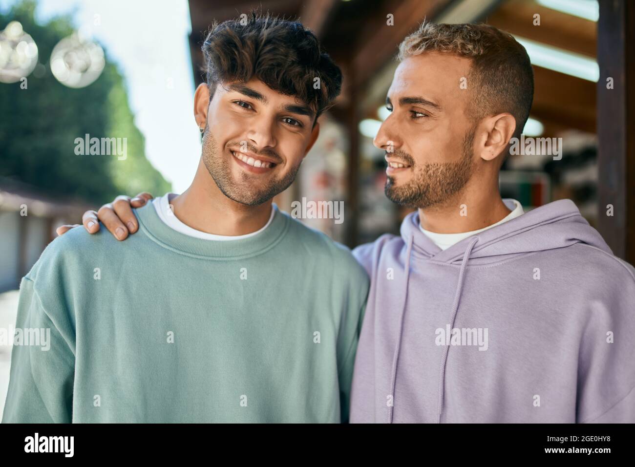Young gay couple smiling happy and hugging at the city Stock Photo - Alamy