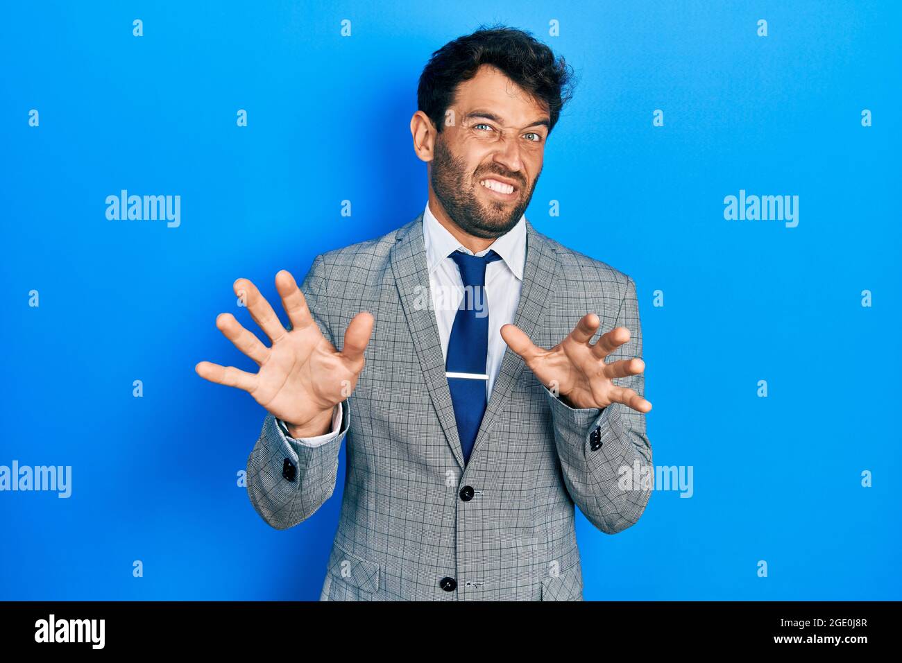 Handsome man with beard wearing business suit and tie disgusted ...