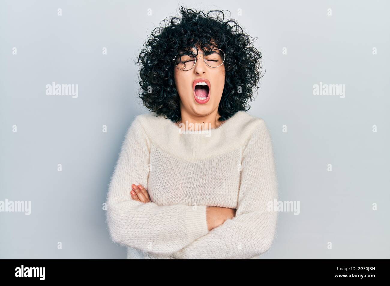 Young middle east woman with arms crossed gesture angry and mad ...