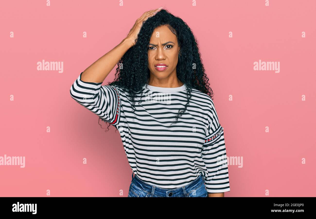 Middle age african american woman wearing casual clothes confuse and ...