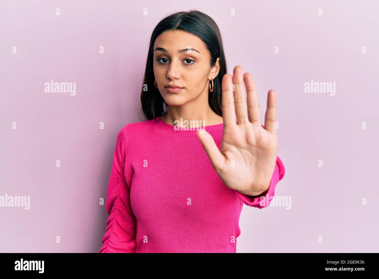 Young hispanic woman wearing casual clothes doing stop sing with palm ...